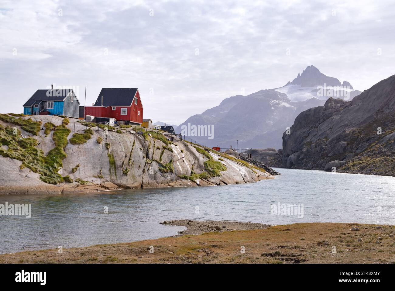 Greenland landscape; colorful buildings, mountains and Fjord; the Inuit ...