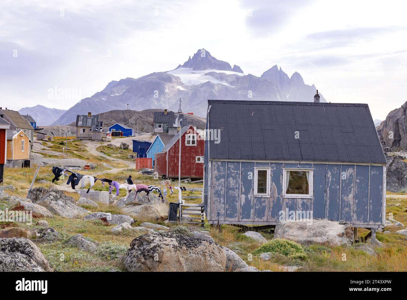 Greenland village; Aappilattoq Inuit village, landscape and mountains ...