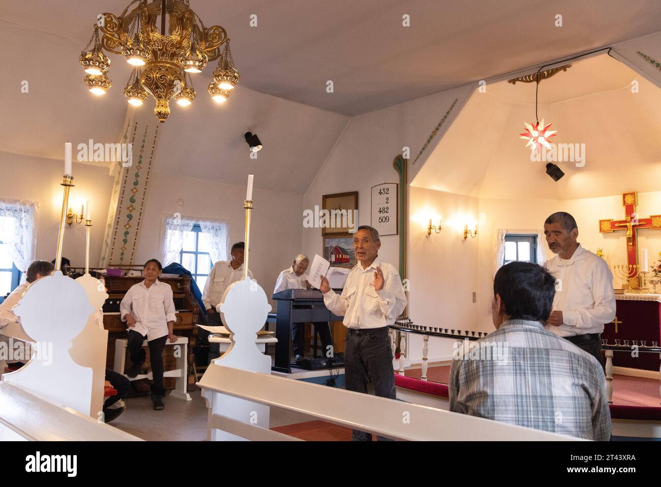 Inuit people; adults singing in an Inuit Village Church interior ...