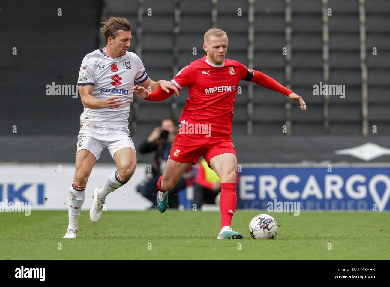 Swindon Town's Frazer Blake-Tracy is challenged by Milton Keynes Dons ...