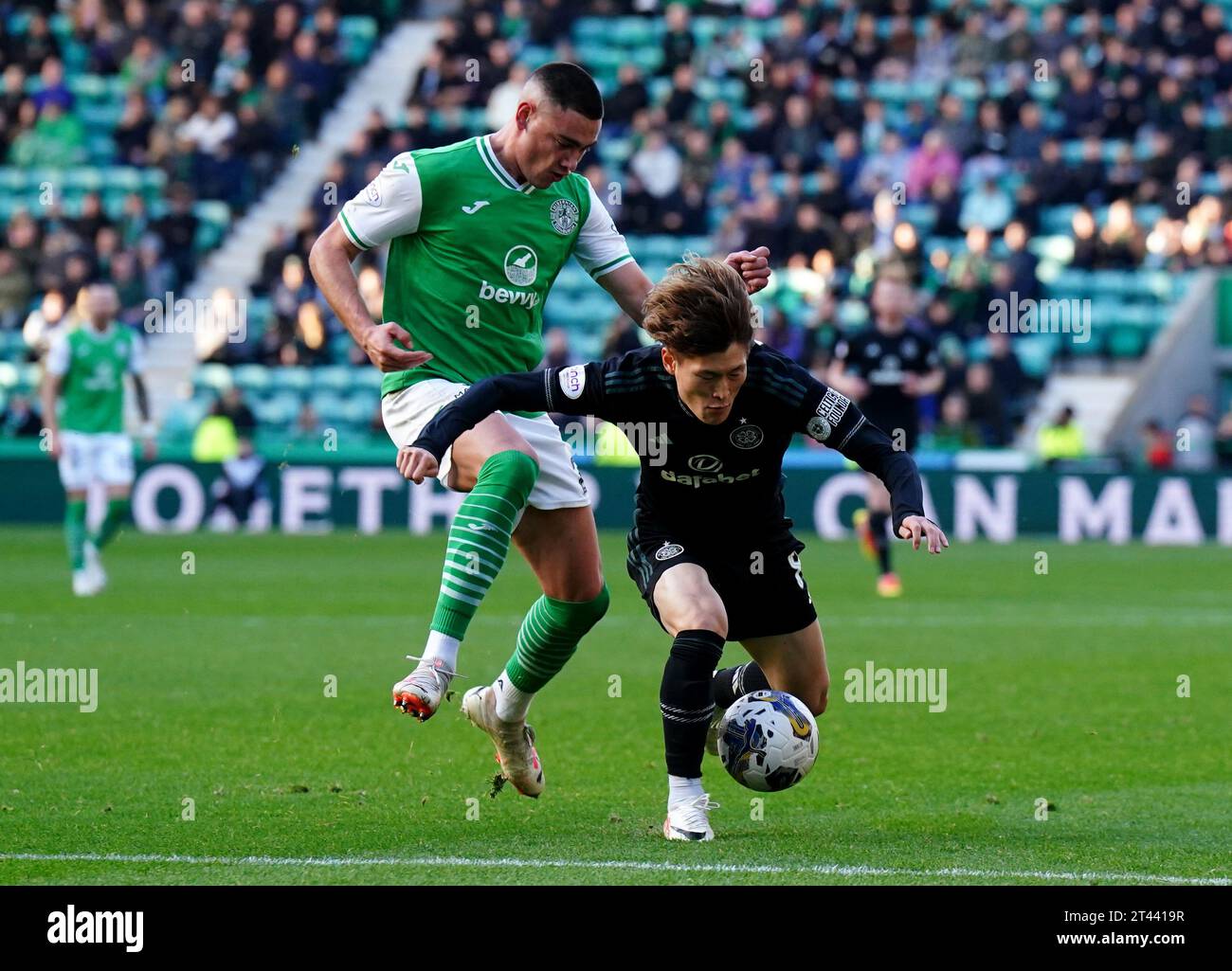 Celtic's Kyogo Furuhashi (right) and Hibernian's Lewis Miller battle ...