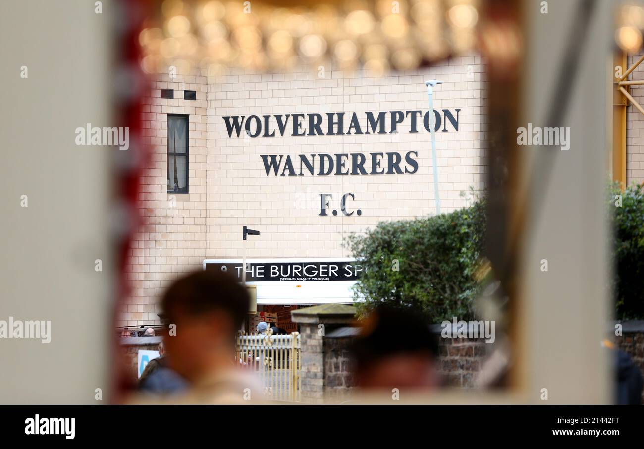 A Wolverhampton Wanderers sign is seen through a window in a food ...