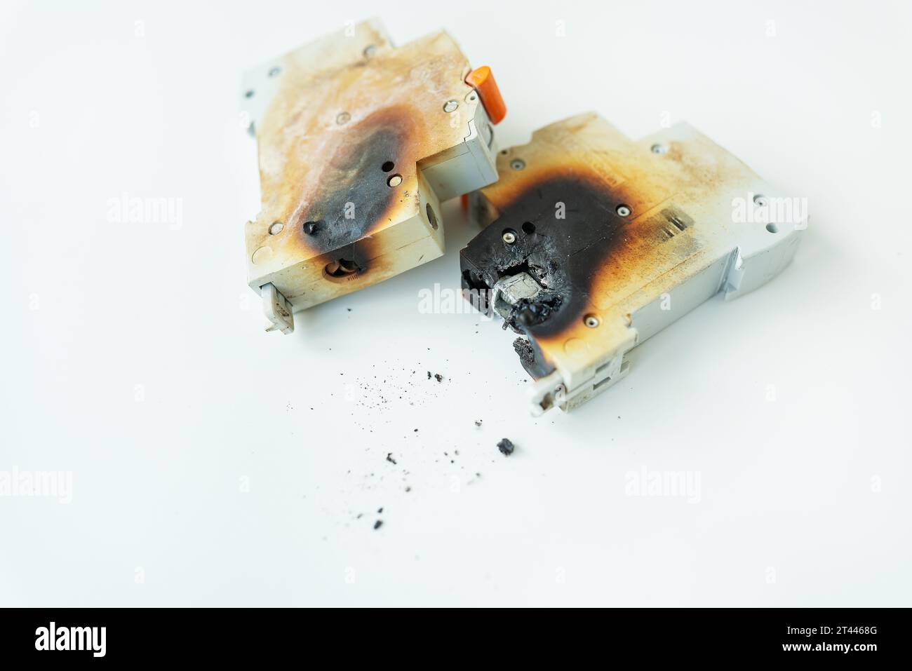 Automatic electrical switch damaged by short circuit, ash on background ...