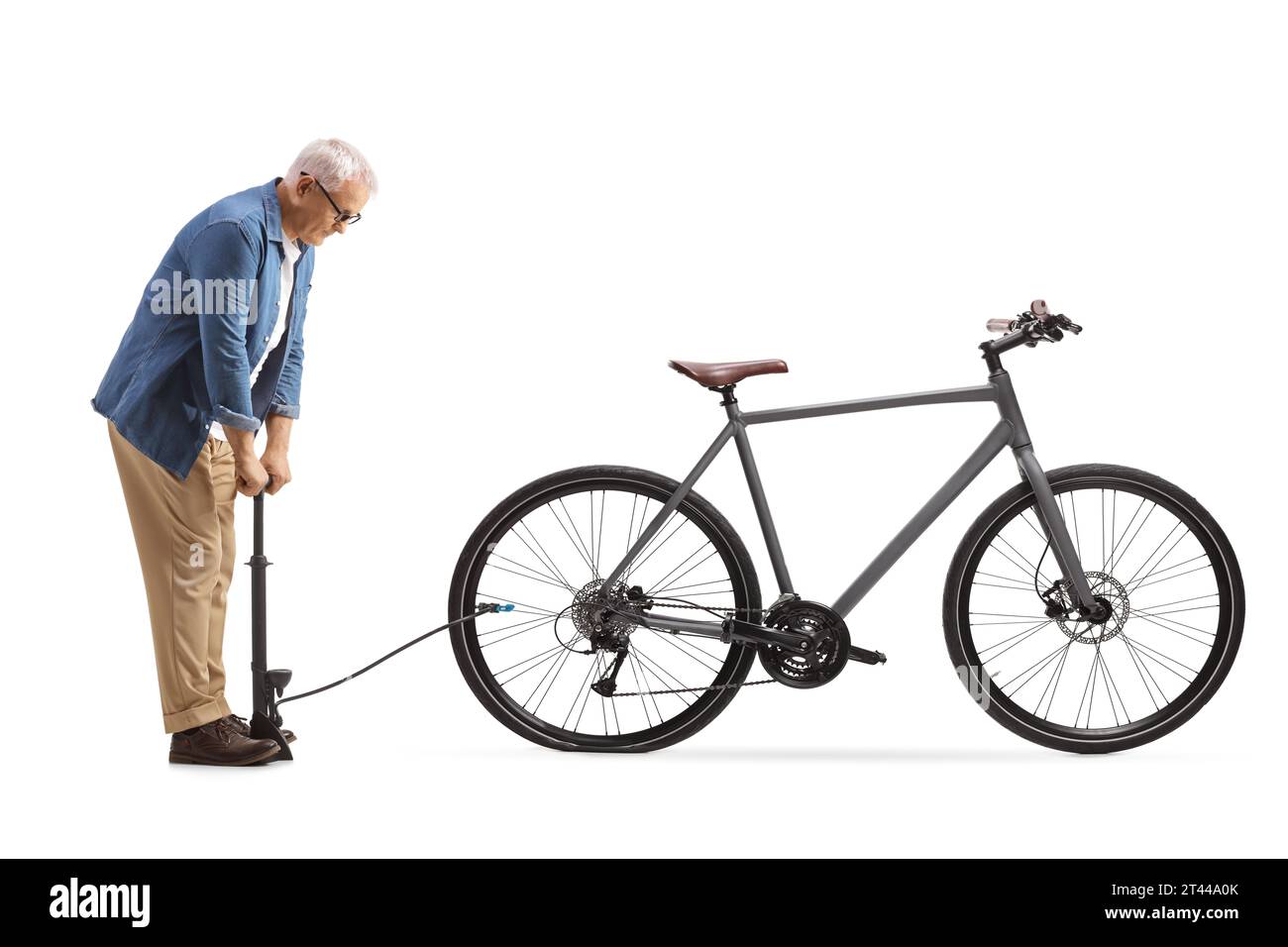 Mature man using a manual pump for a bicycle tire isolated on white ...
