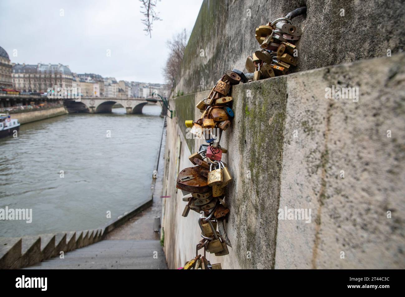 Love locks adorn the railing along the Seine River near the iconic ...