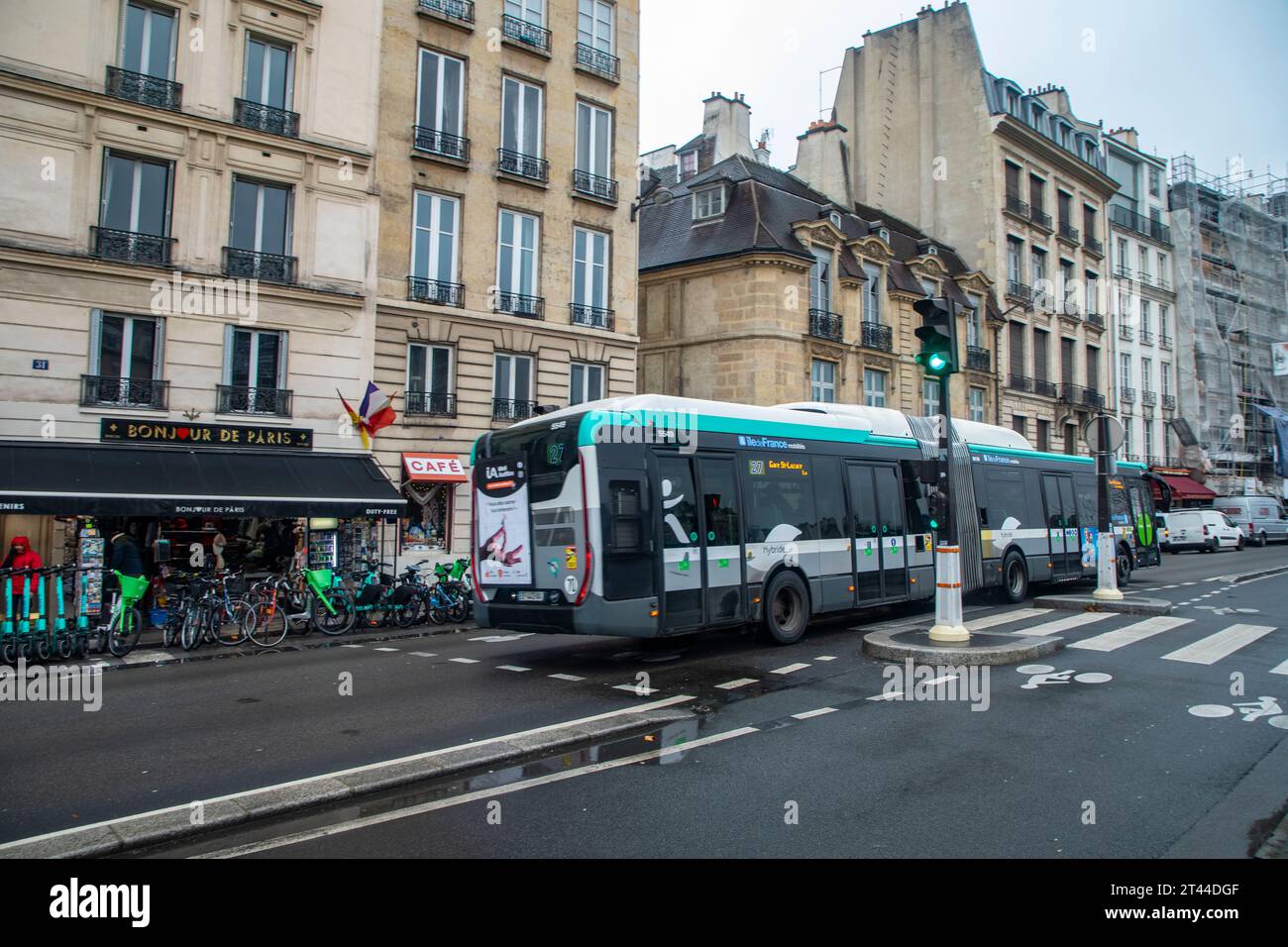 An articulated city bus navigates the streets of Paris, France, as part ...