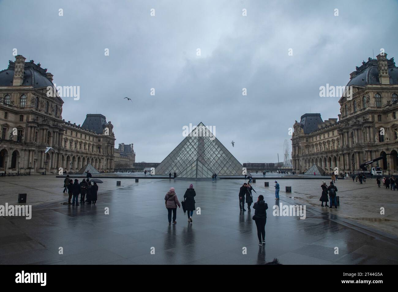 Visitors outside the Louvre art gallery and Museum entrance Paris ...