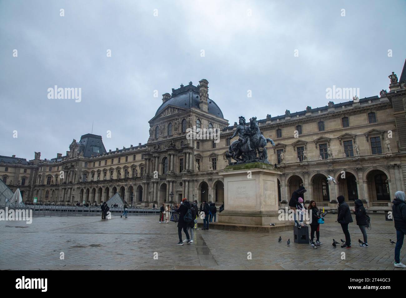 Visitors outside the Louvre art gallery and Museum entrance Paris ...