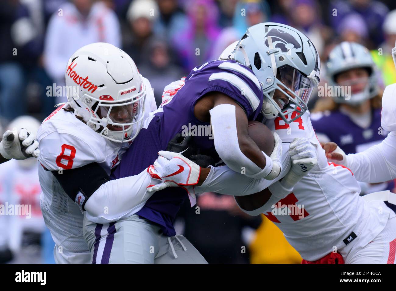 Kansas State running back DJ Giddens, center, is wrapped up by Houston ...