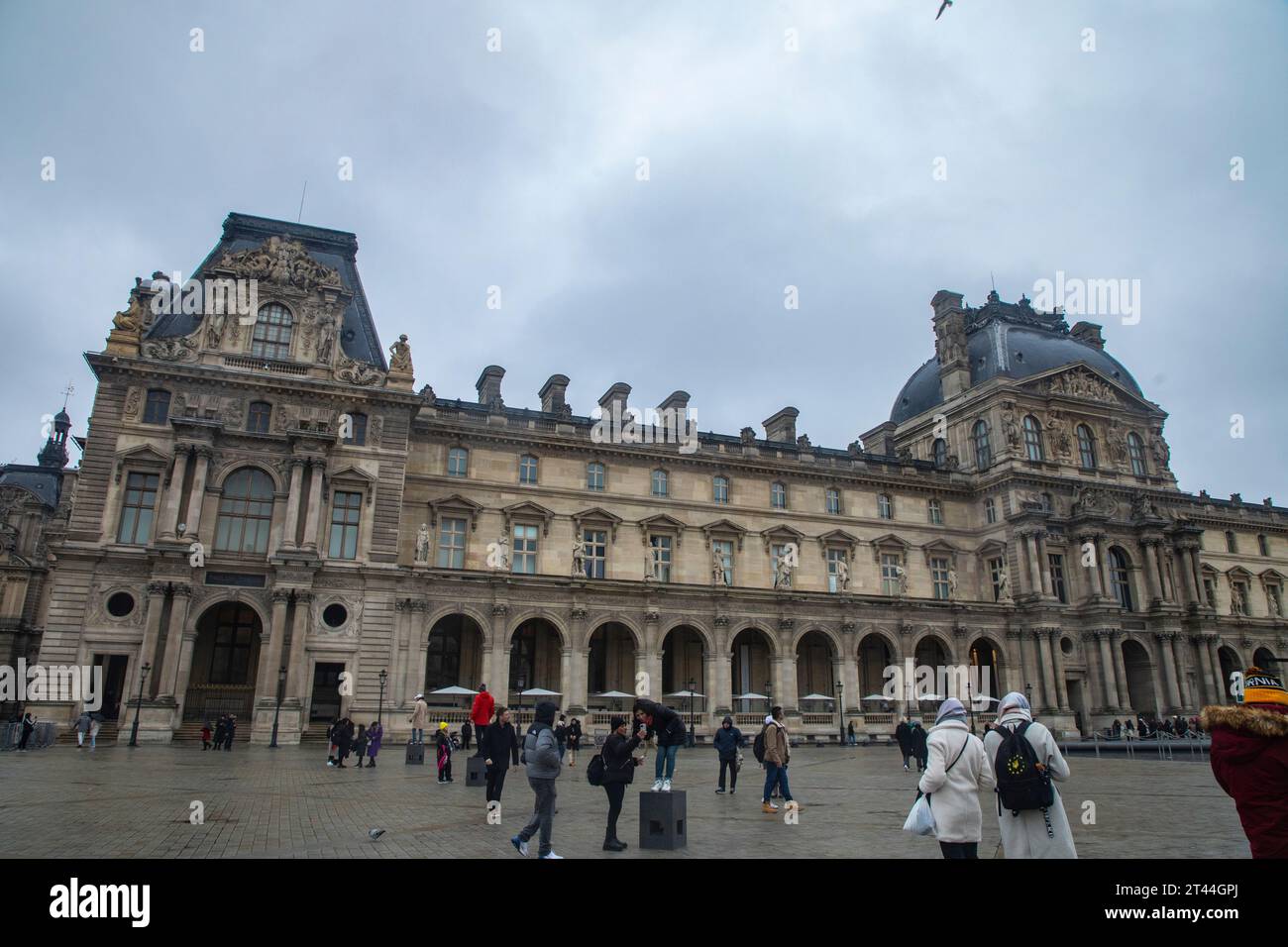 Visitors outside the Louvre art gallery and Museum entrance Paris ...