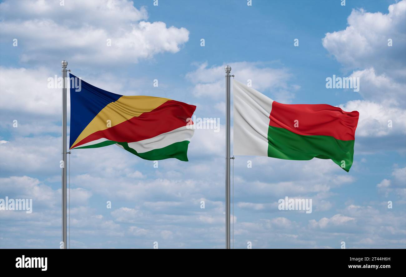 Madagascar and Seychelles flags waving together on blue cloudy sky, two country relationship ...