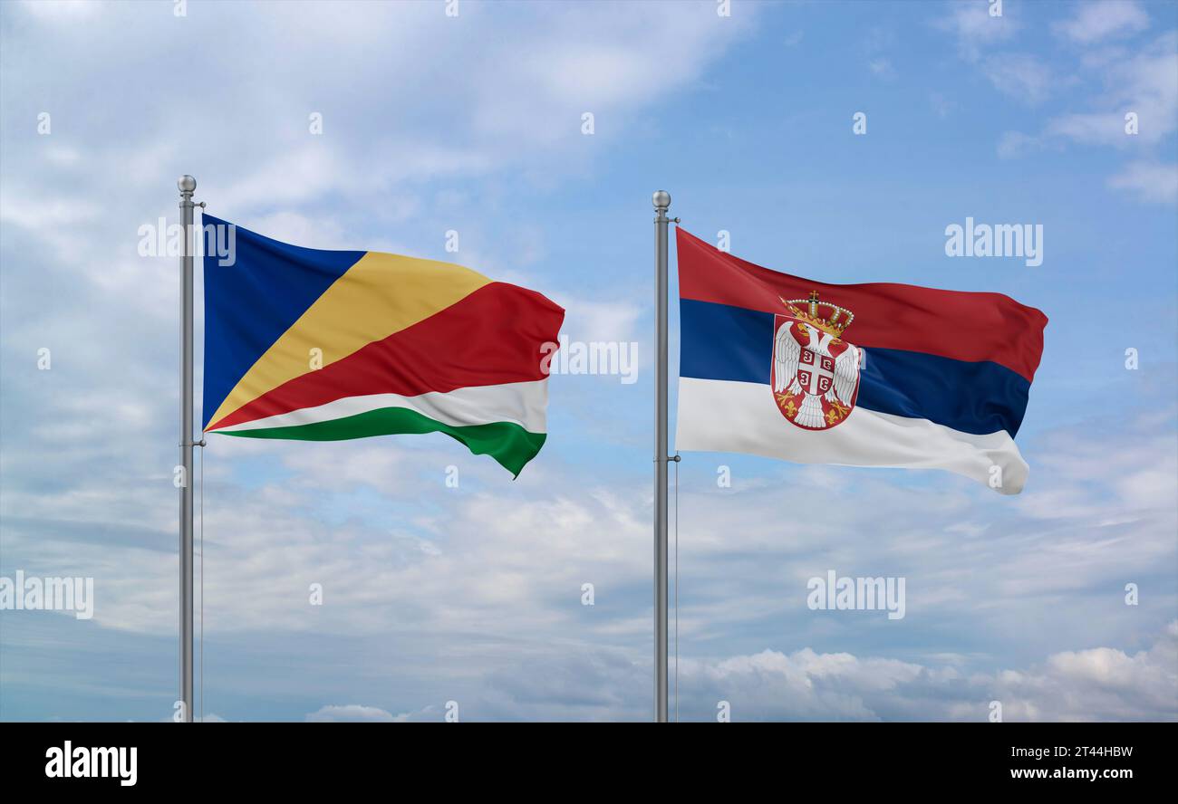Republic of Serbia and Seychelles flags waving together in the wind on blue cloudy sky, two ...