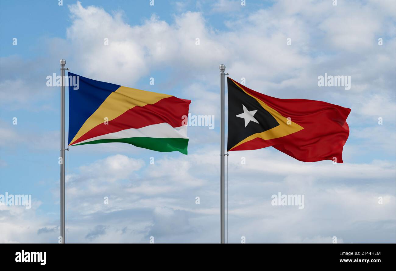 East Timor and Seychelles flags waving together in the wind on blue cloudy sky, two country ...