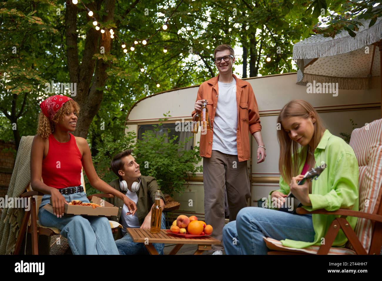 Happy teenagers friends enjoying summer camping trip having fun time ...