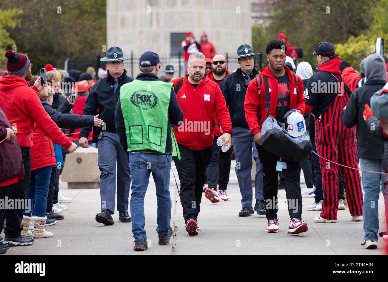 Nebraska head coach Matt Rhule, center, and linebacker Mikai Gbayor ...