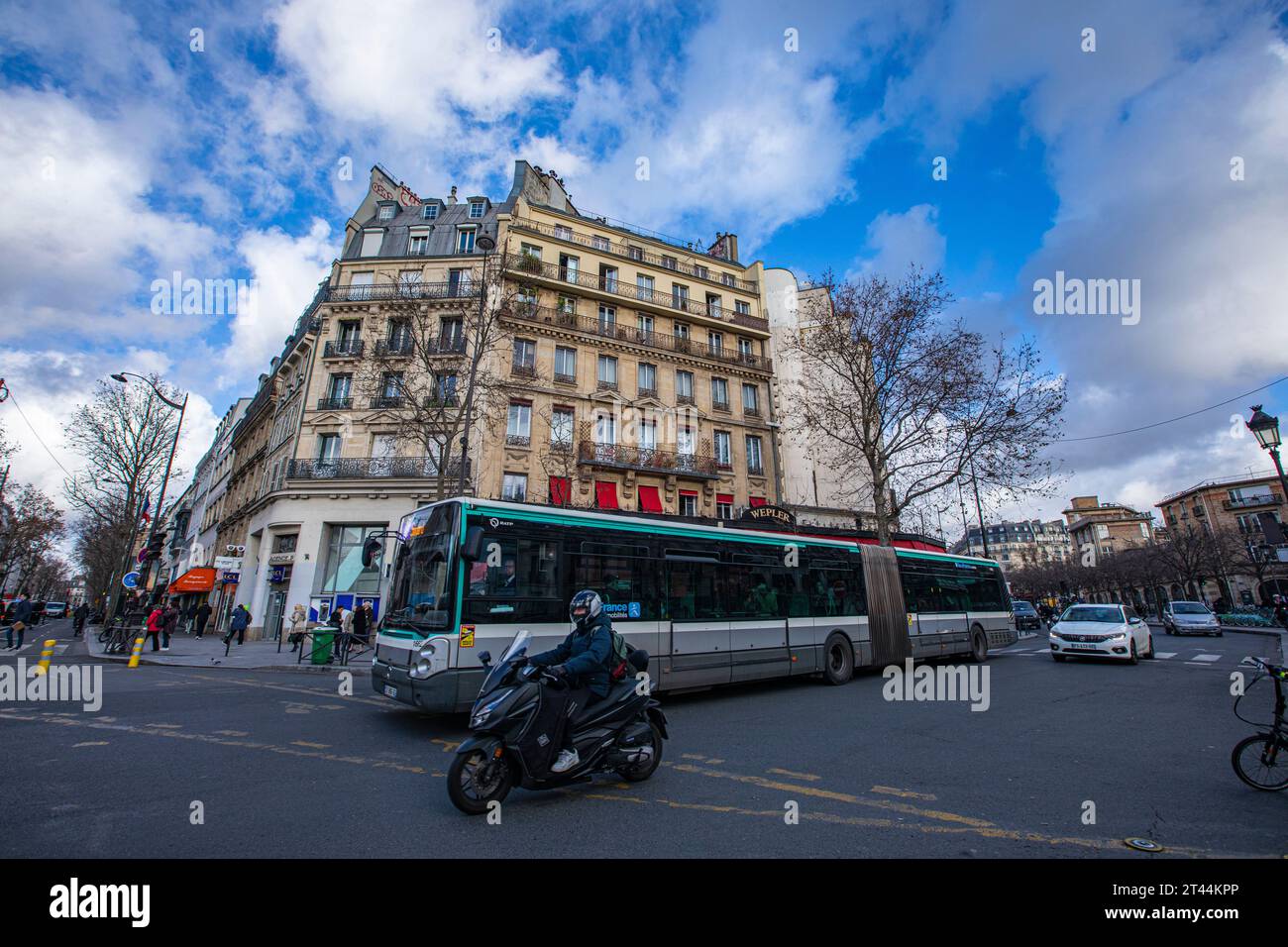 An articulated city bus navigates the streets of Paris, France, as part ...