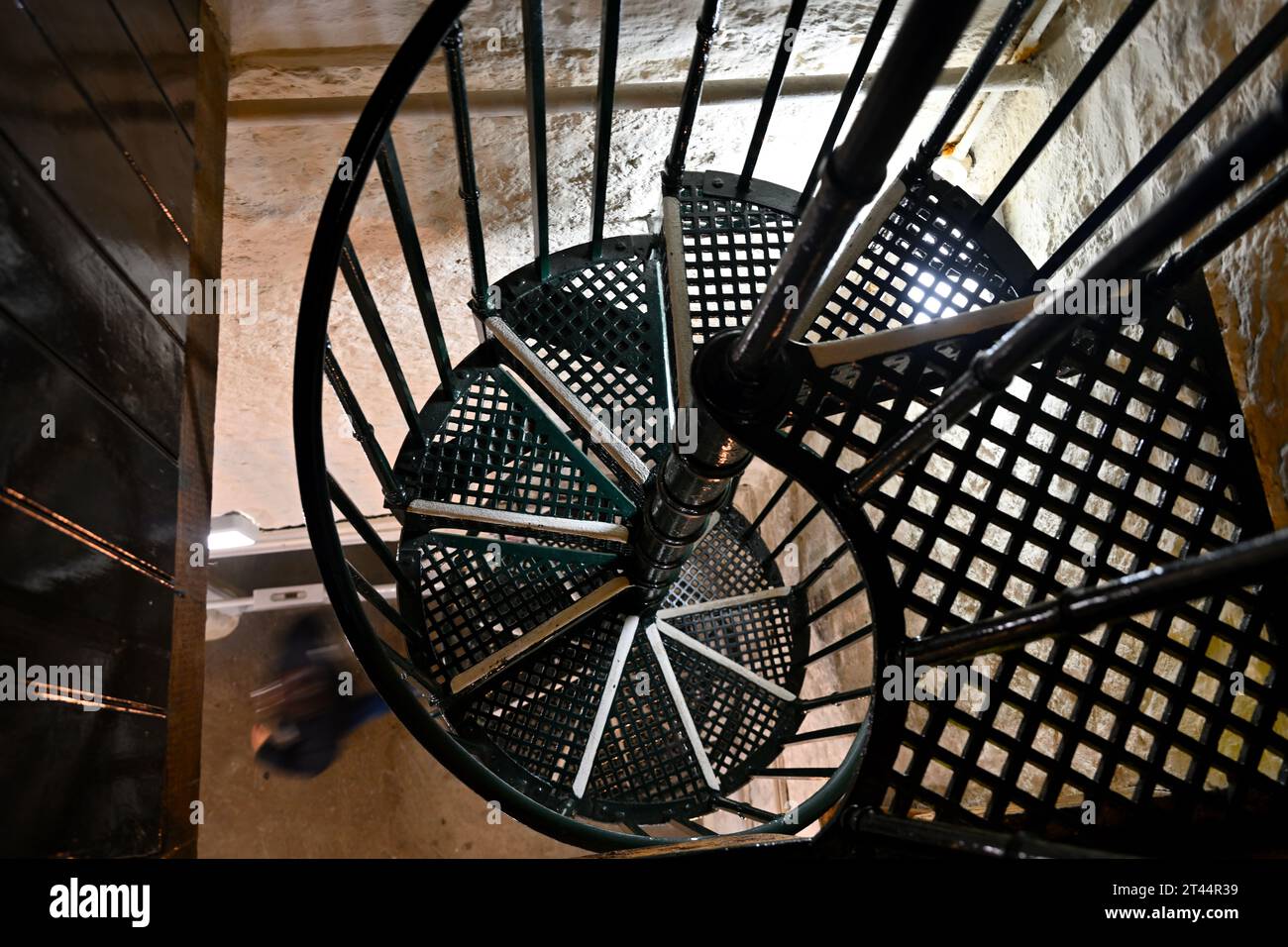 Looking down spiral metal staircase in bell town of historic church ...