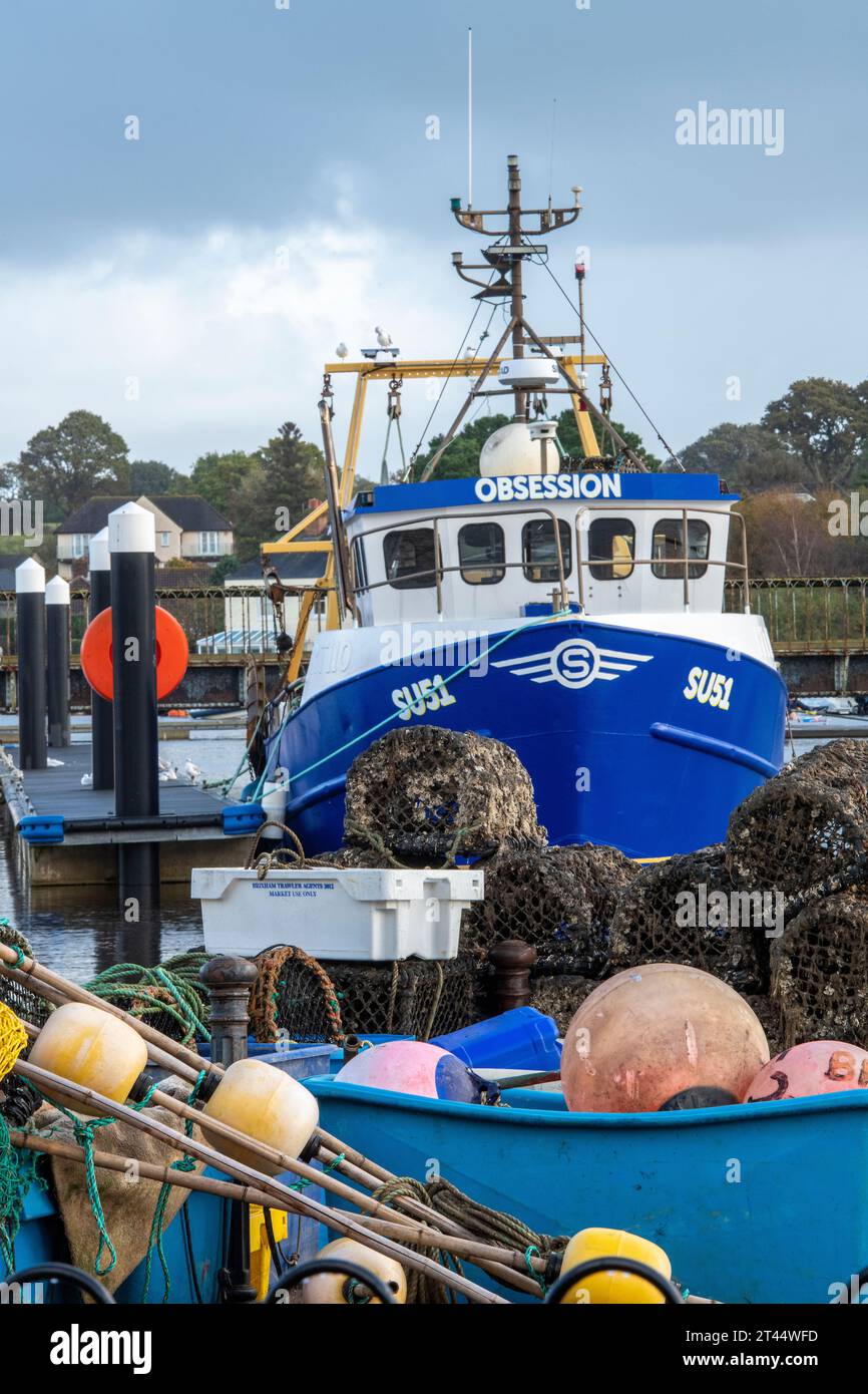 inshore trawler with fishing equipment floats and buoys alongside in ...