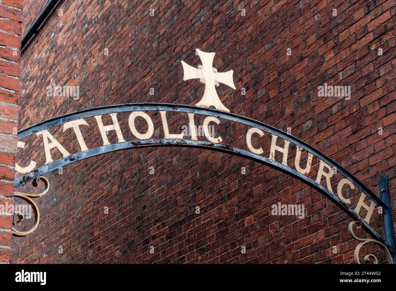 vintage or antique catholic church wrought iron sign above entance ...