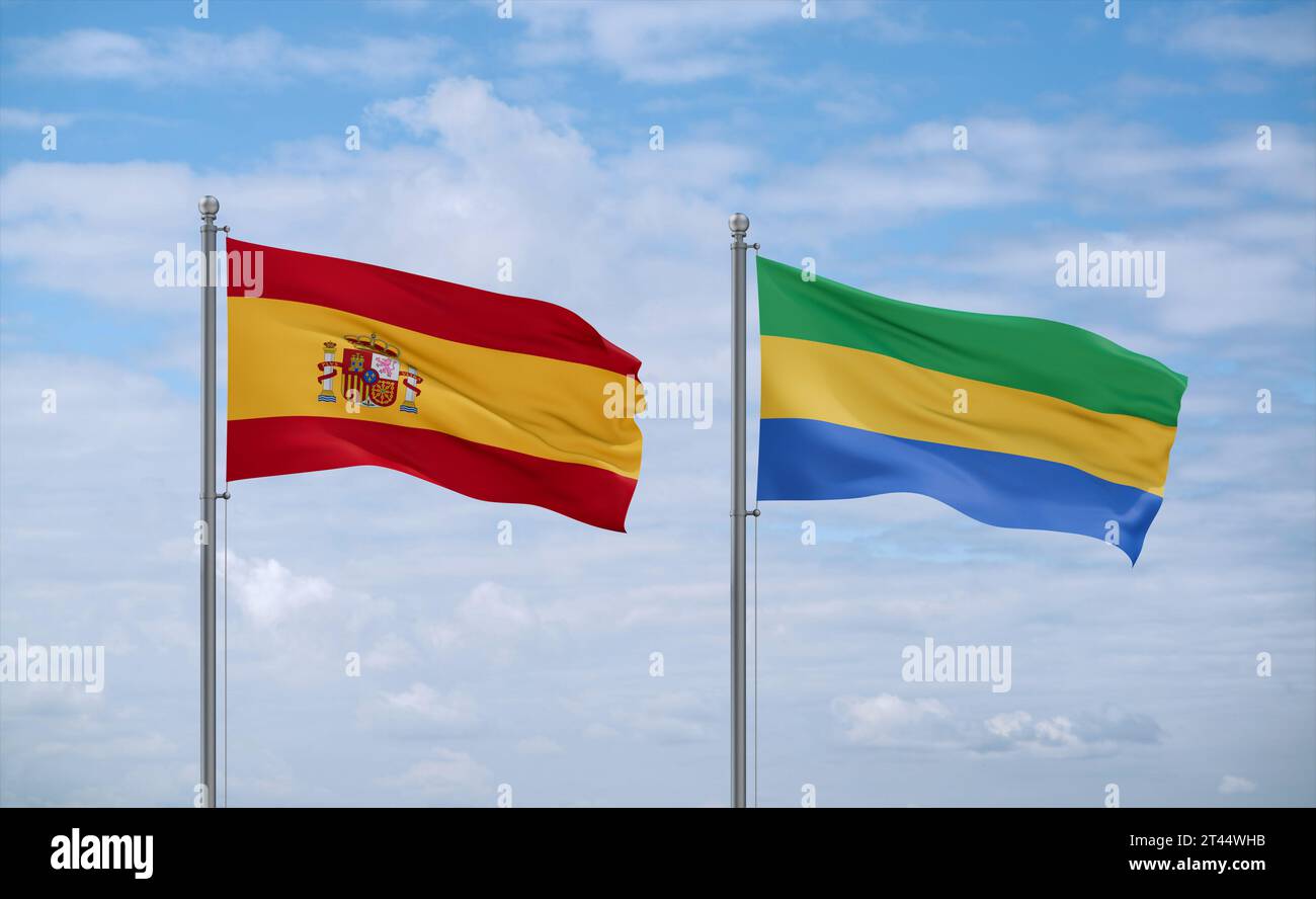 Gabon and Spain flags waving together on blue cloudy sky, two country relationship concept Stock ...