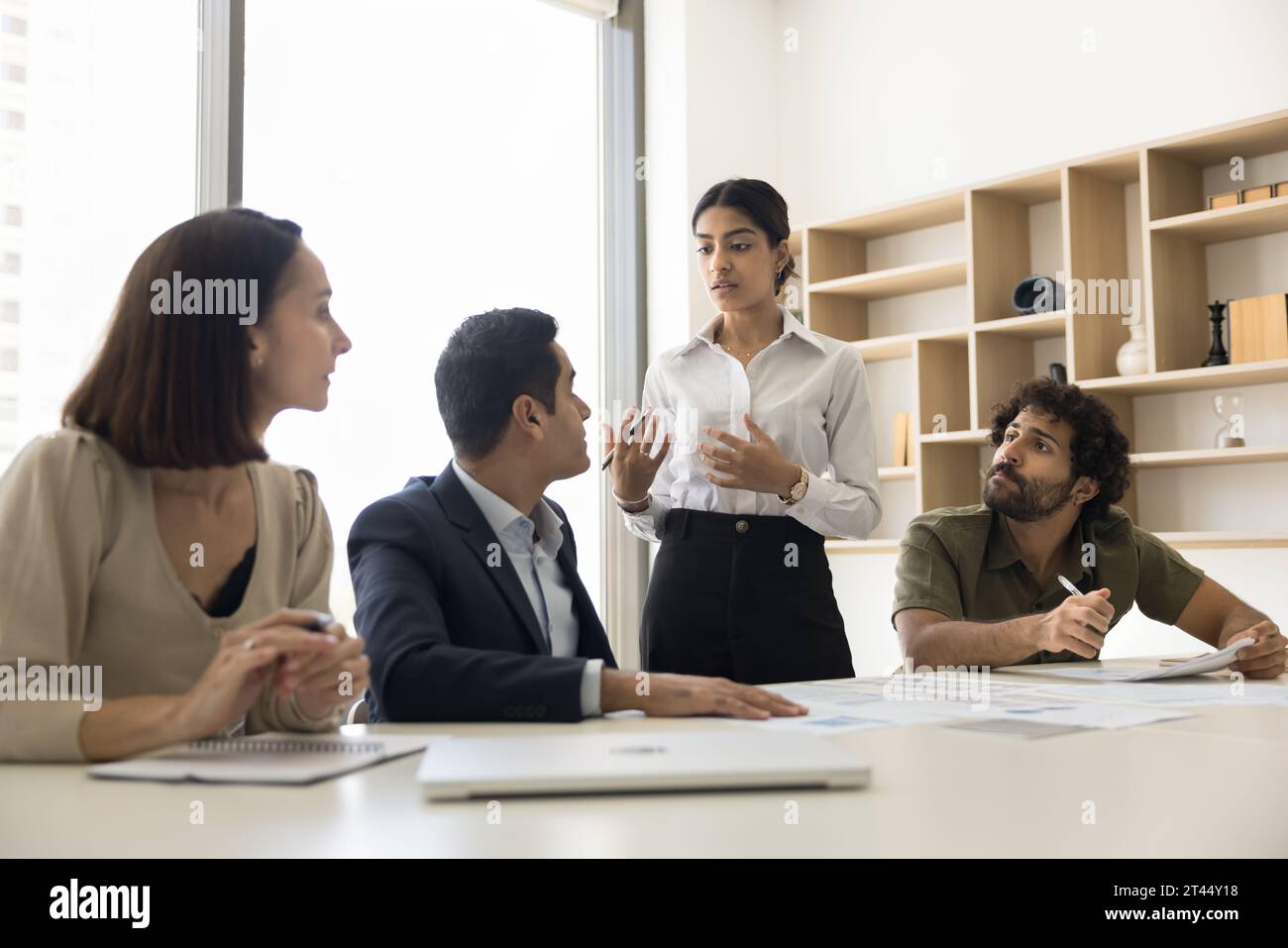 Serious young Indian professional woman coaching company staff Stock ...