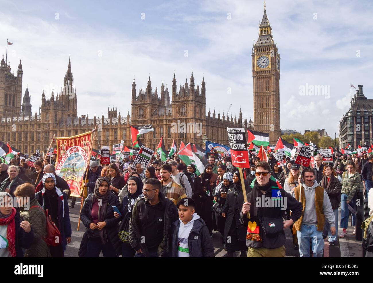 London, UK. 28th October 2023. Protesters march on Westminster Bridge ...