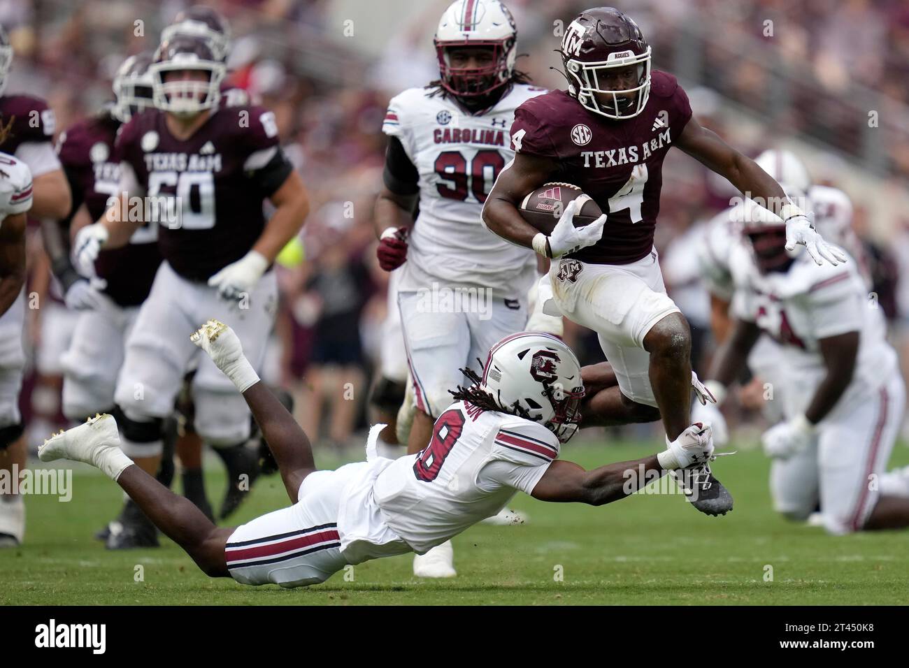 Texas A&M running back Amari Daniels (4) steps out of a tackle attempt ...