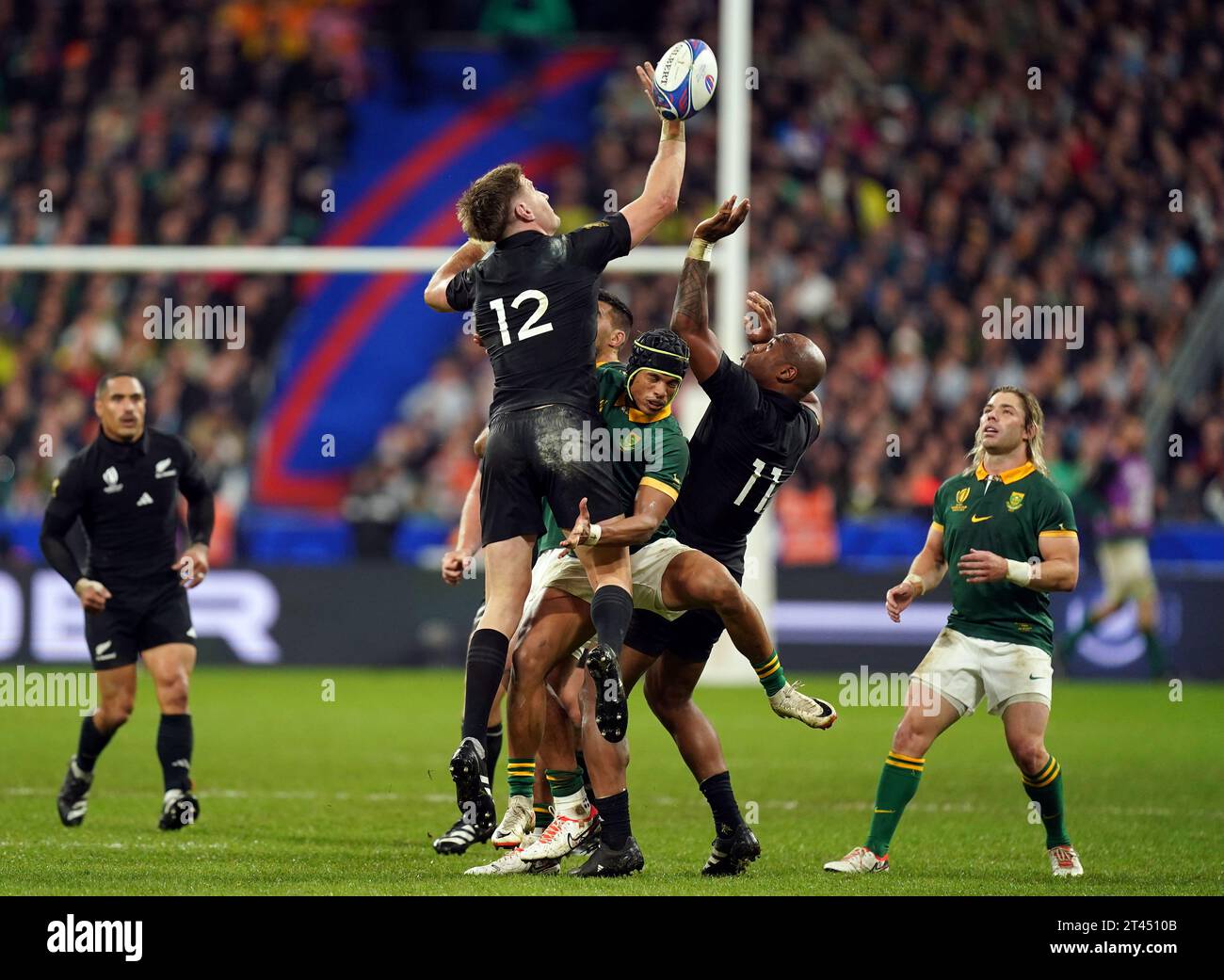 New Zealand's Jordie Barrett (left) and Mark Tele'a (11) challenge ...