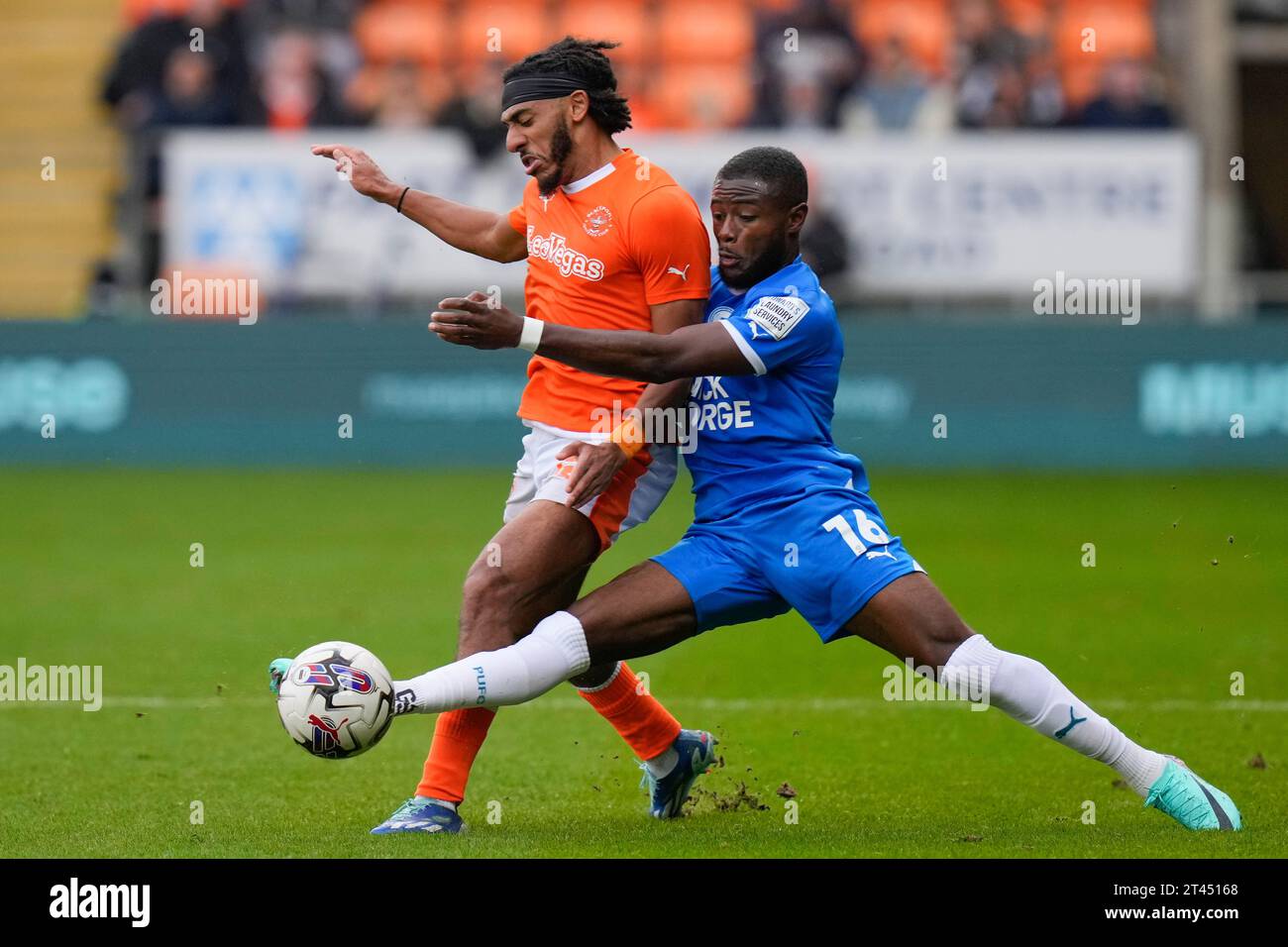 David Ajiboye #16 of Peterborough United competes with Dominic Thompson ...