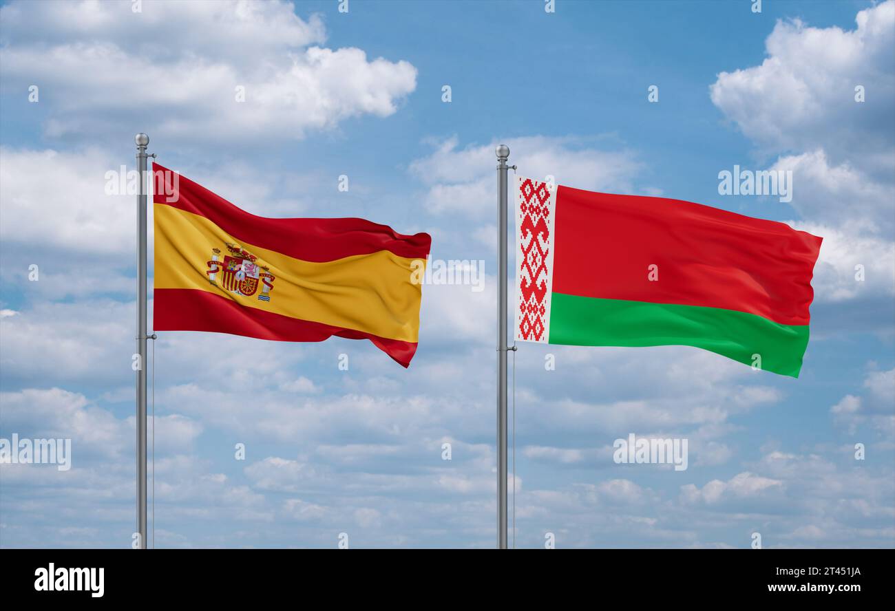 Belarus and Spain flags waving together in the wind on blue cloudy sky ...
