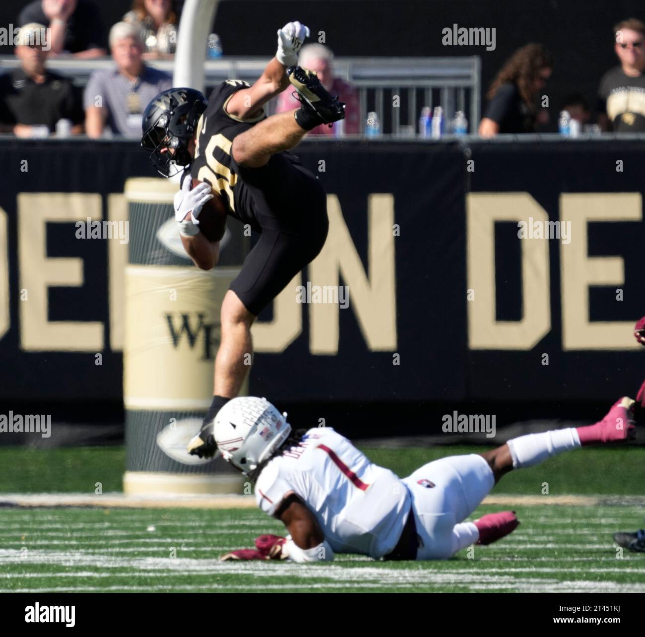 Wake Forest running back Tate Carney (30) leaps over Florida State ...