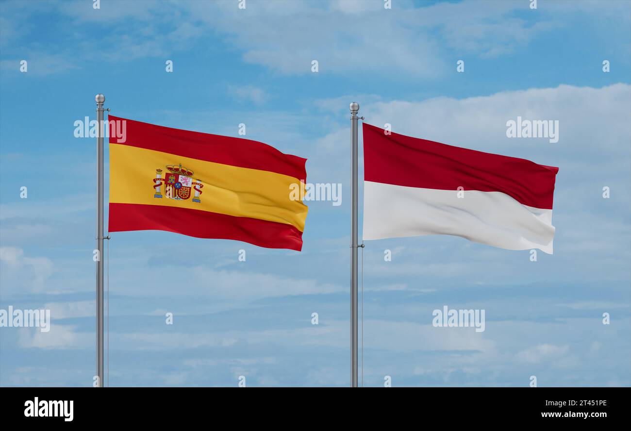 Indonesia and Spain flags waving together on blue cloudy sky, two ...