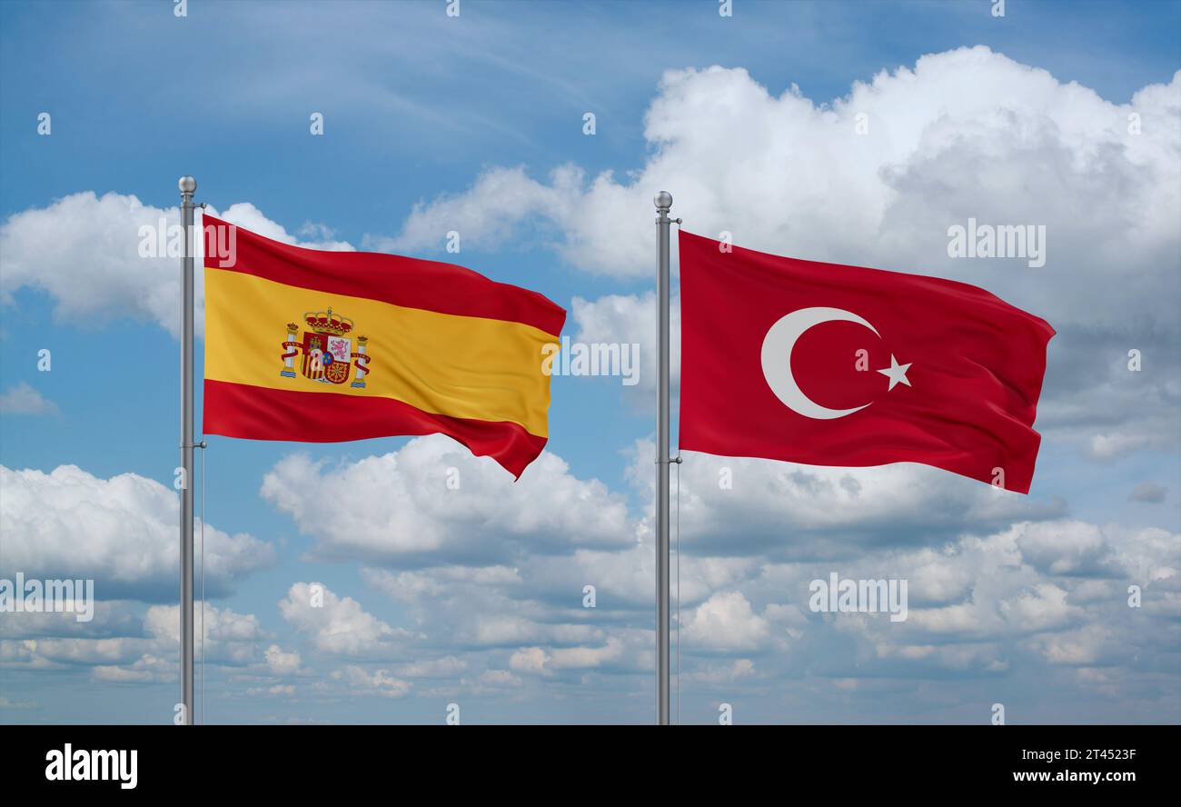 Republic of Turkey and Spain flags waving together in the wind on blue ...
