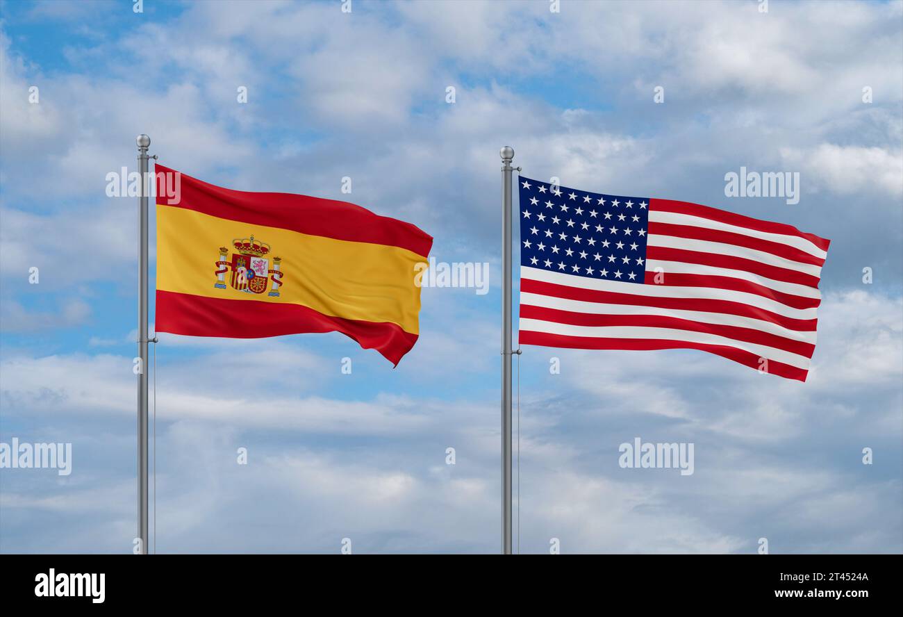 USA and Spain flags waving together in the wind on blue cloudy sky, two ...