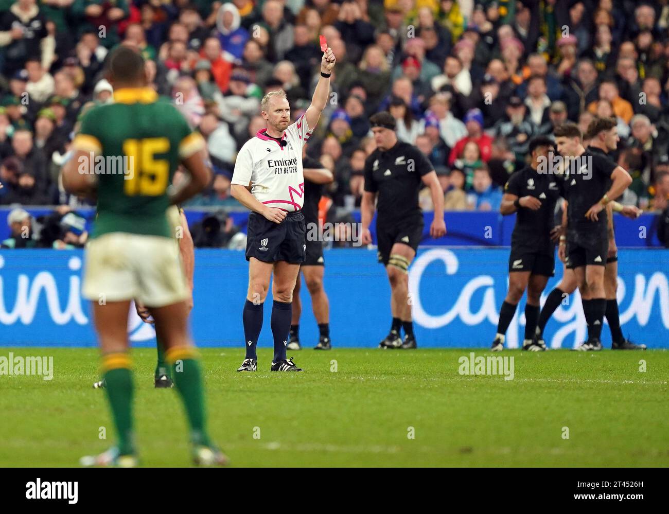 Referee Wayne Barnes shows a red card to New Zealand's Sam Cane ...