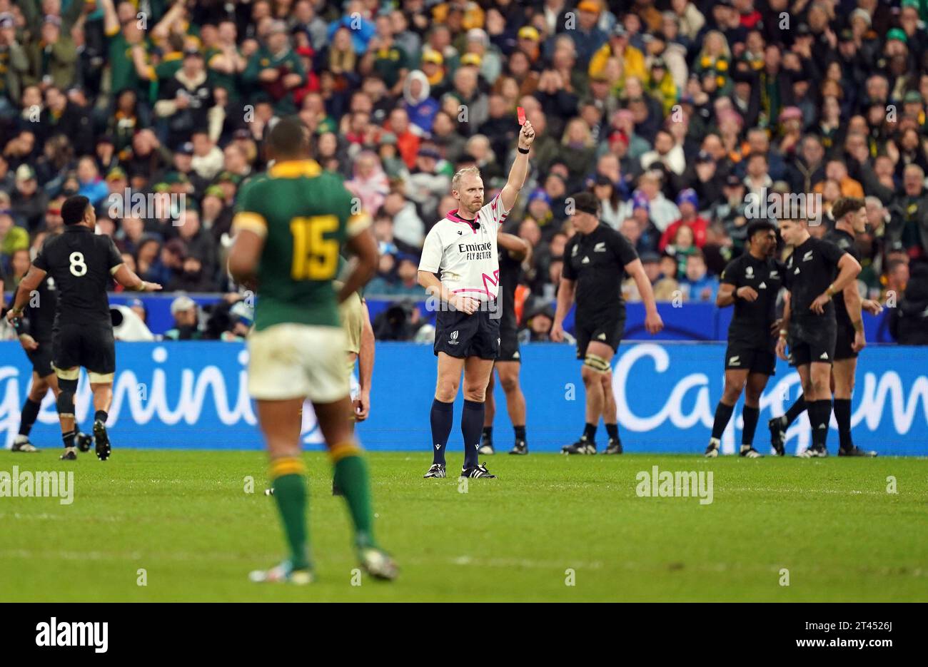 Referee Wayne Barnes shows a red card to New Zealand's Sam Cane ...