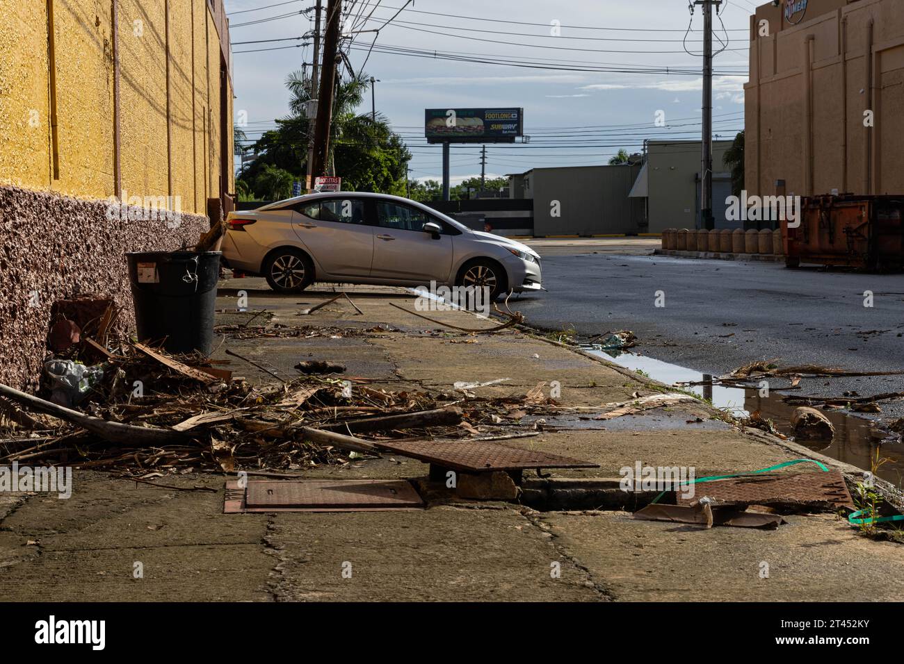 Puerto Rico. 28th Oct, 2023. A stranded car left on the curb and trash ...