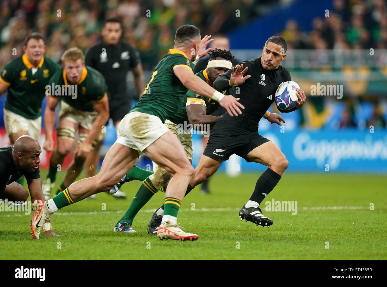 New Zealand's Aaron Smith hands off South Africa's Jesse Kriel (left ...