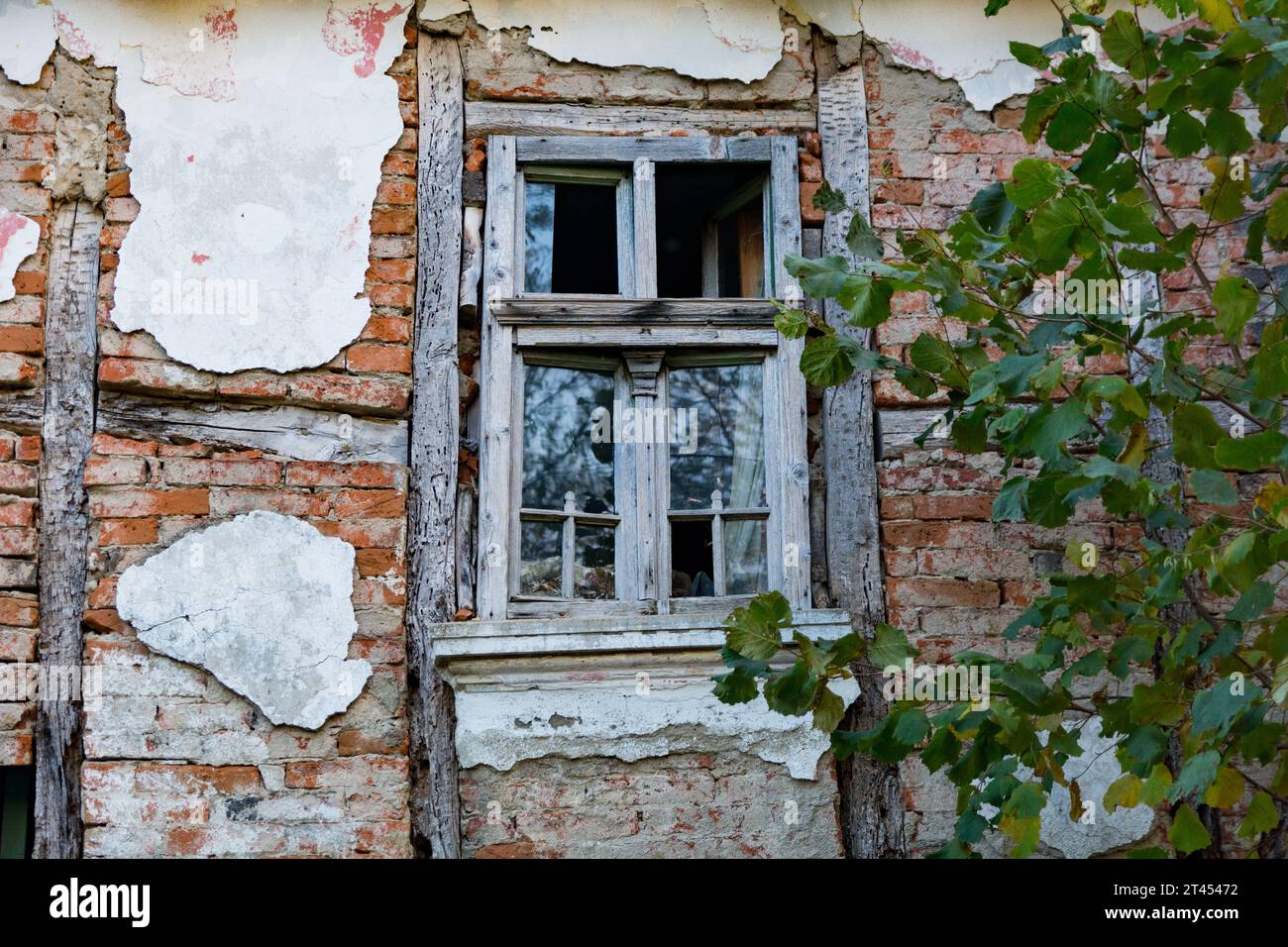 Vintage green window with shattered glass on a weathered house ...