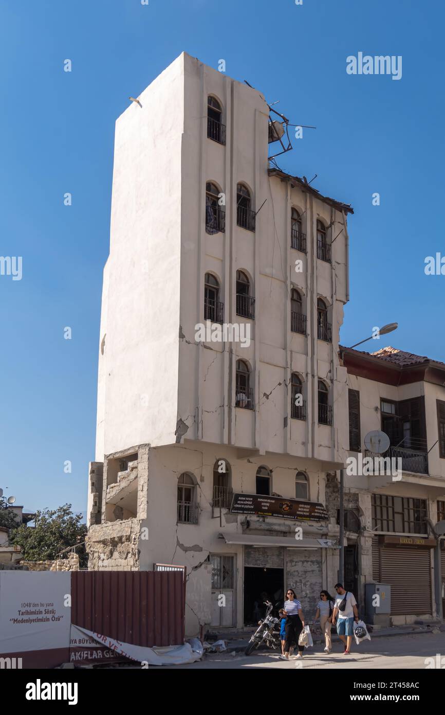 People pass the historic building cracked and semi-collapsed after ...