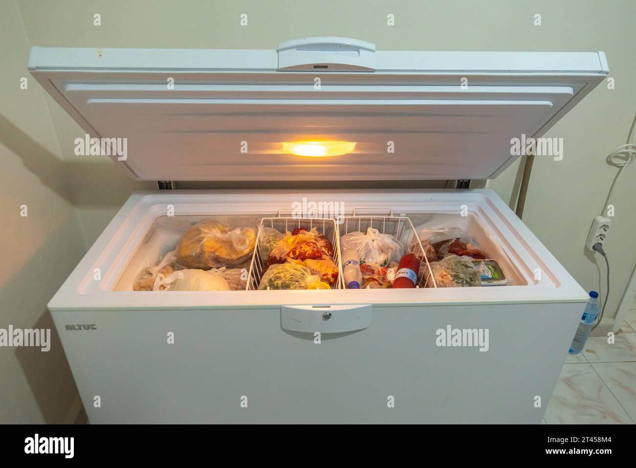 Opened freezer filled with frozen food Stock Photo - Alamy