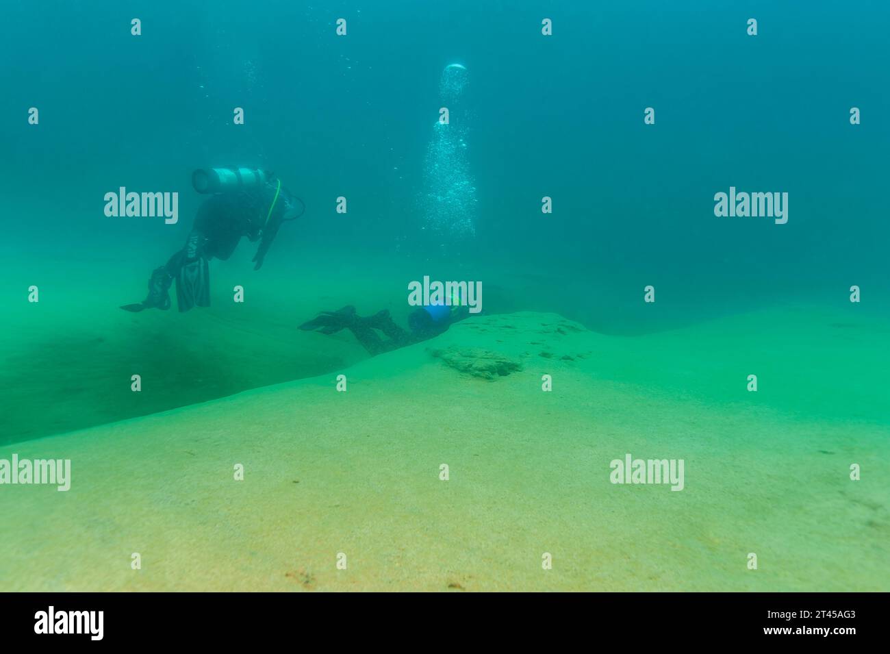 Munising, MI -August 11th, 2023: Two SCUBA divers exploring a crevice ...