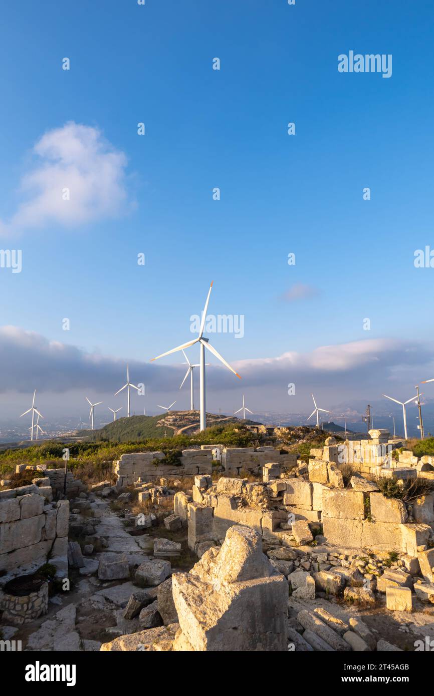 Wind turbines in Hatay Turkey behind the ruins of historic Monastery of ...