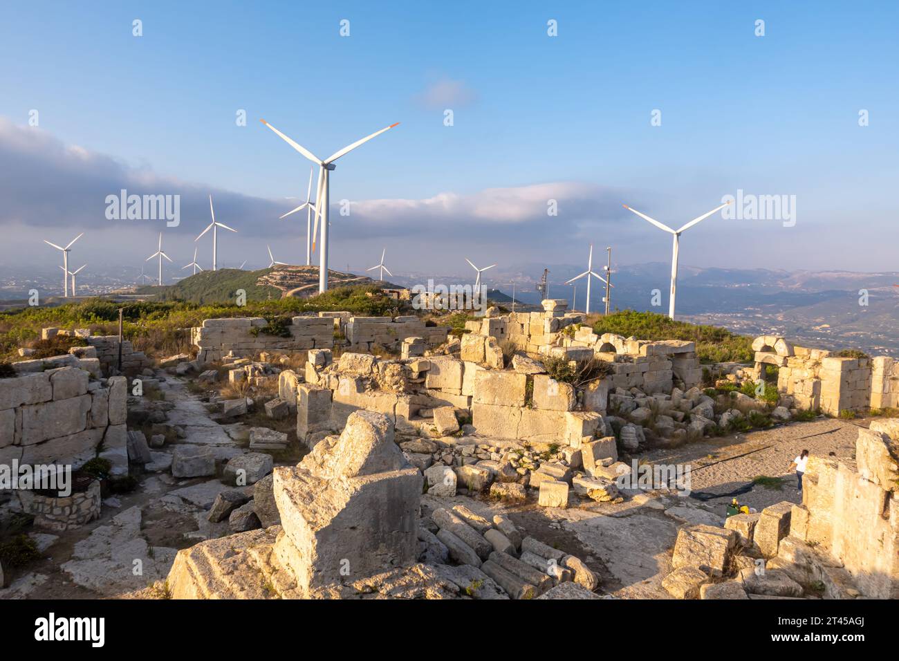 Wind turbines in Hatay Turkey behind the ruins of historic Monastery of ...