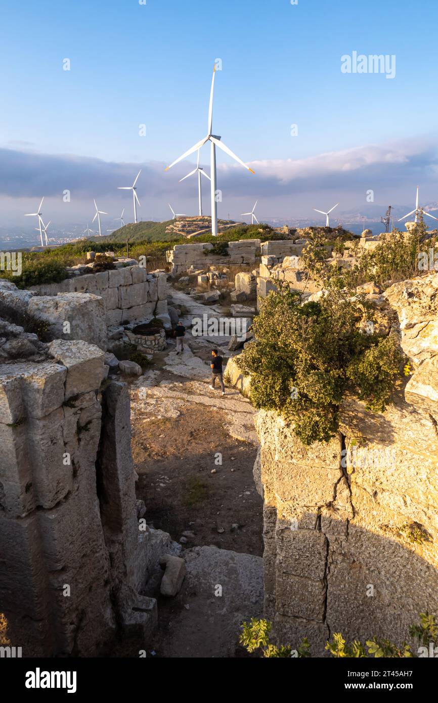 Wind turbines in Hatay Turkey behind the ruins of historic Monastery of ...