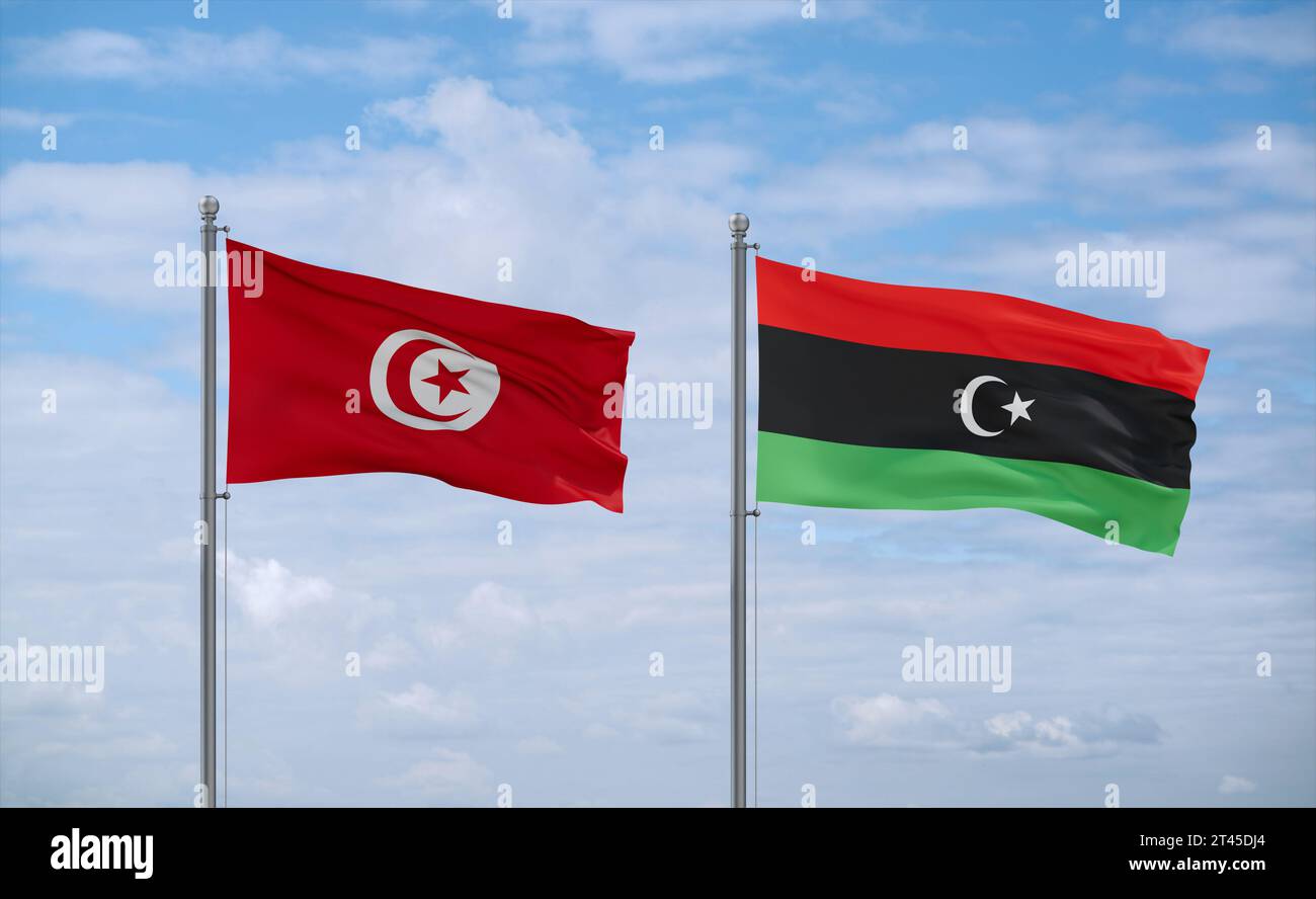 Libya and Tunisia flags waving together in the wind on blue cloudy sky ...