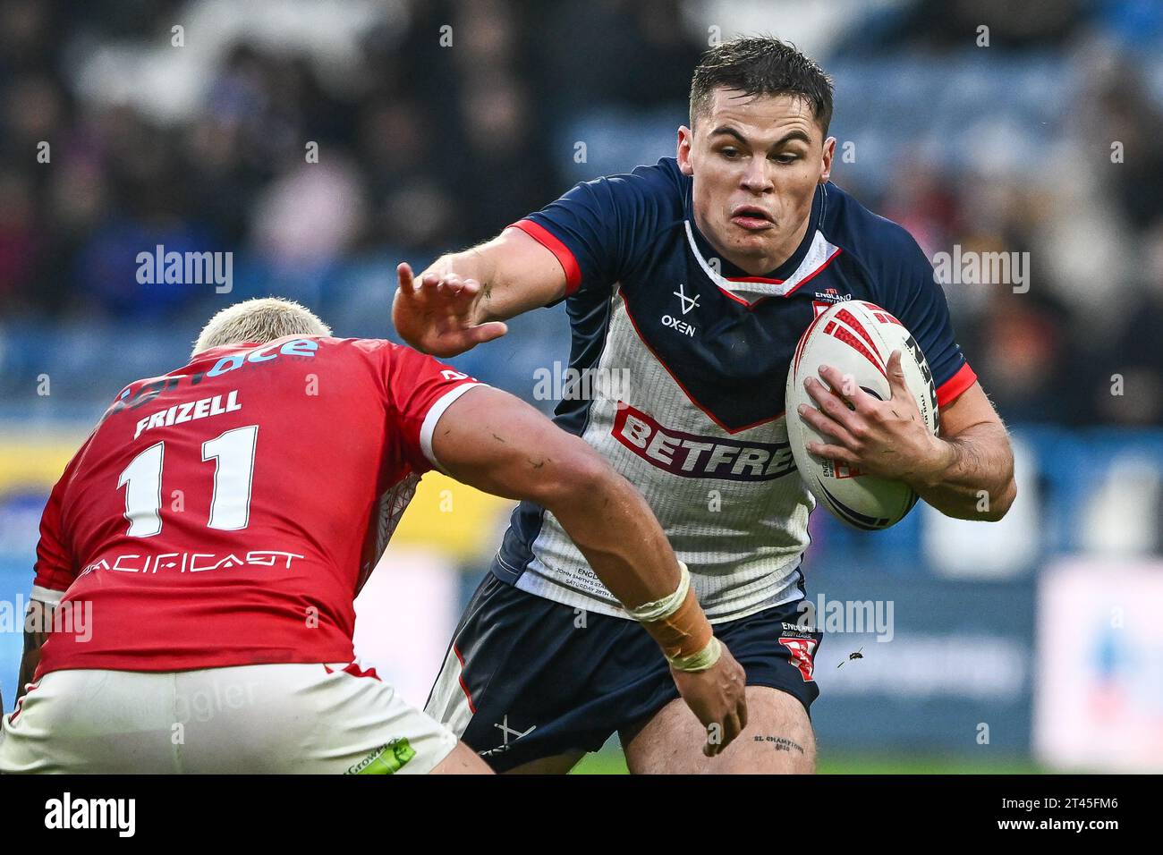 Jack Welsby of England is tackled by Tyson Frizell of Tonga during the ...