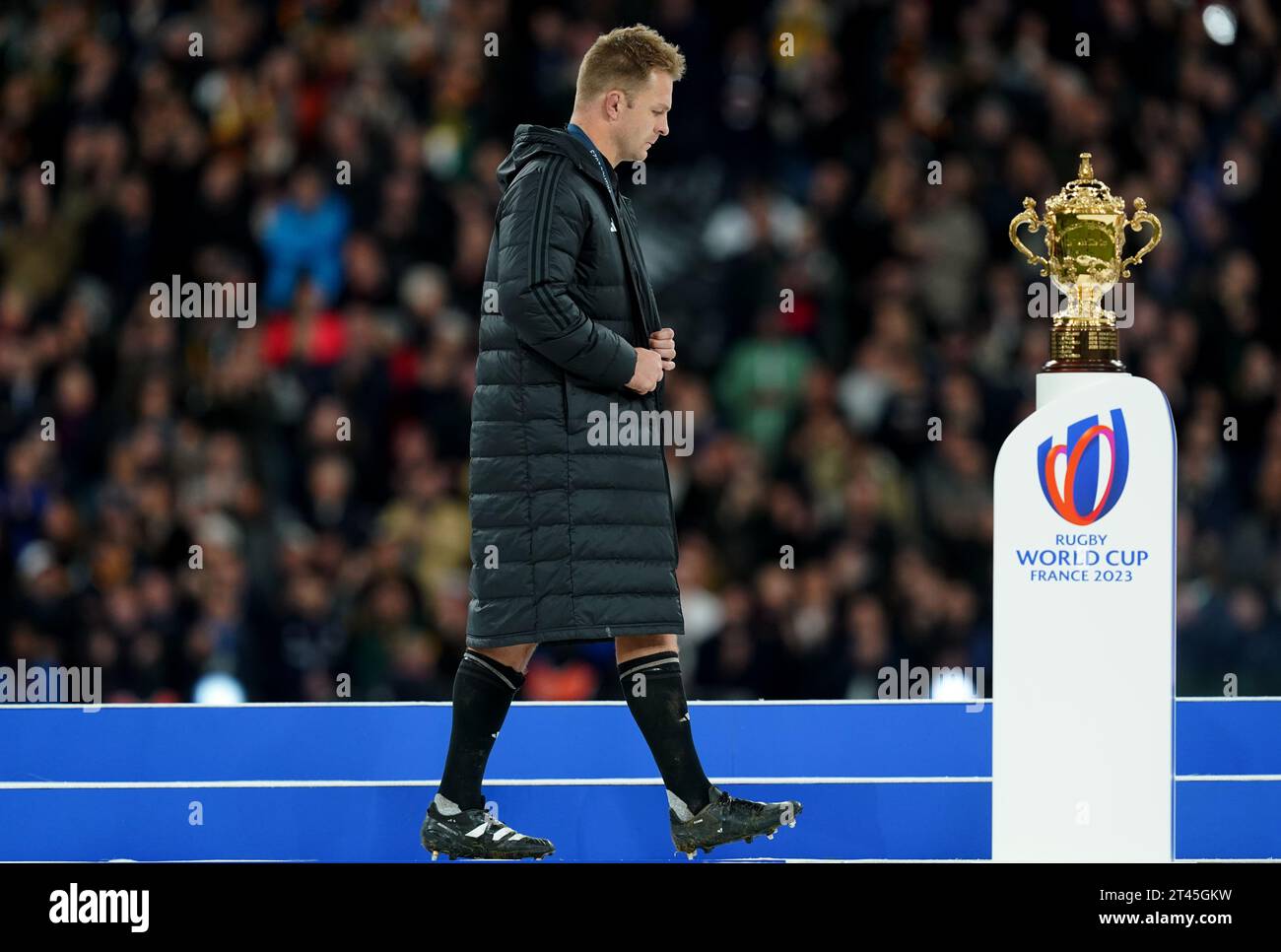 New Zealand's Sam Cane walks past the Webb Ellis Cup following defeat ...