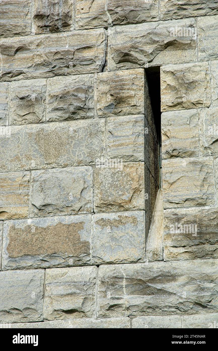 Close up of limestone block masonry obelisk with deep slotted window ...