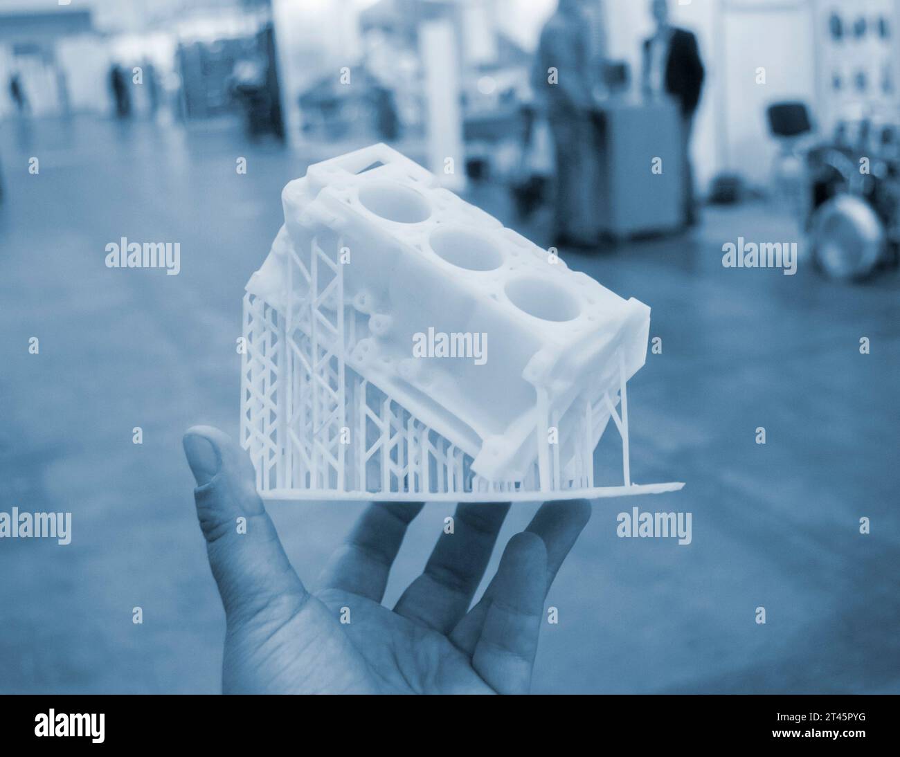 Person holding in palm of hand prototype of car engine printed on 3D ...